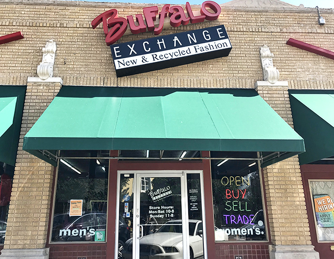 The green awnings frame Buffalo Exchange's entrance like curtains to a fashion show where yesterday's trends become tomorrow's treasures.