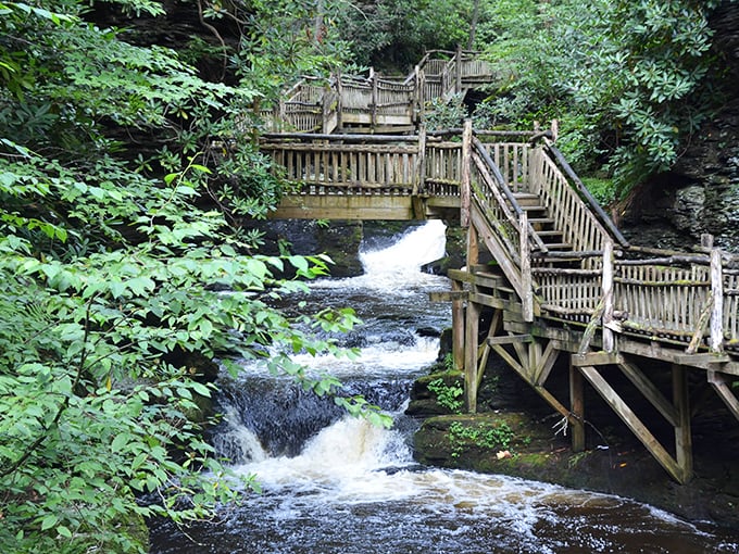 Wooden walkways guide you through Bushkill's forest cathedral, where water performs its timeless dance over ancient rocks.