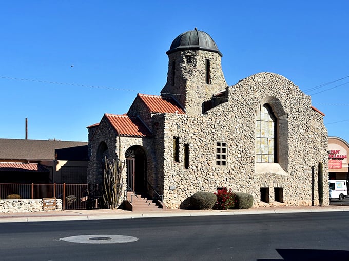 A charming gazebo stands ready for community gatherings in Casa Grande, surrounded by swaying palms and desert blooms.