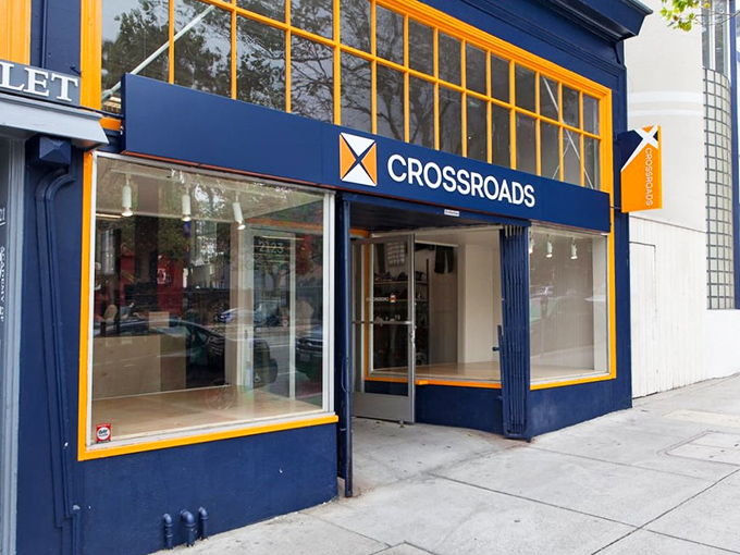 The clean lines and professional signage of Crossroads Trading suggest this isn't your grandmother's thrift store experience.