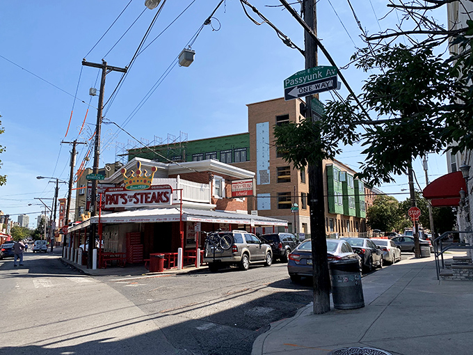 Pat's corner kingdom catches the morning light, ready for another day of cheesesteak glory. That crown isn't just for show.