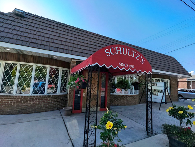 Schultz's Crab House: That red awning is like a beacon for crab lovers. The yellow flowers add a touch of "welcome home" charm.