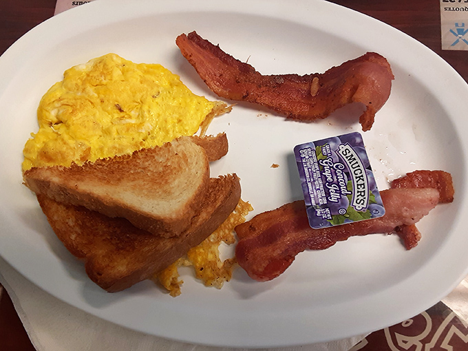 Simple perfection on a plate—eggs, toast, and bacon arranged in the universal language of "good morning" that needs no translation.