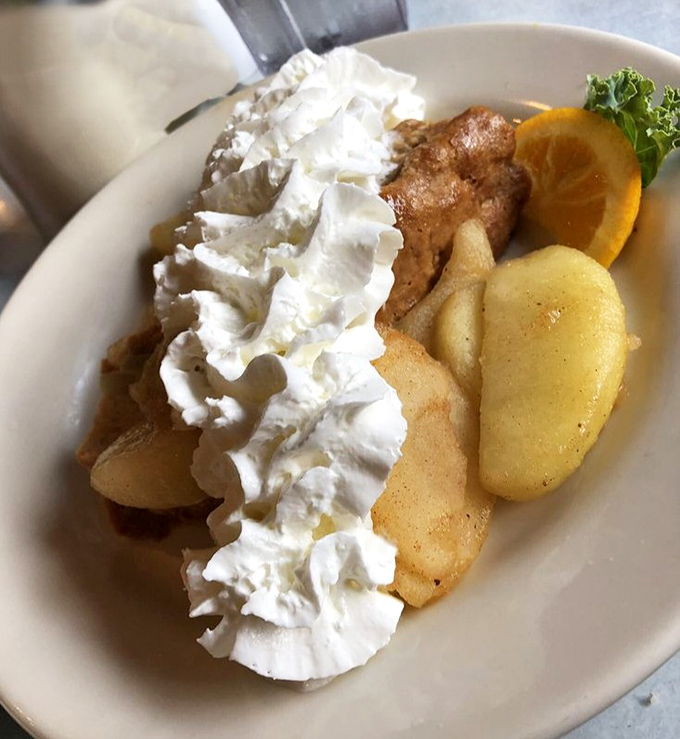 French toast that makes you question every other breakfast decision you've ever made. That mountain of whipped cream isn't just decoration&mdash;it's a lifestyle choice.