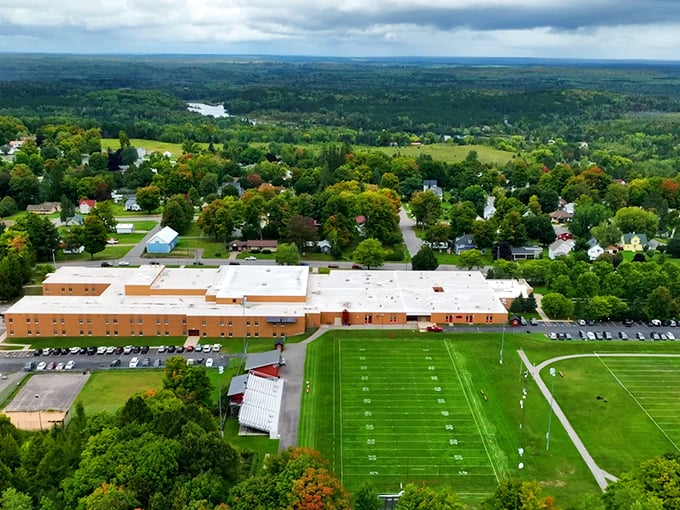 From above, Forest Park School anchors the community like a ship in a sea of trees, where Friday night football becomes the town's heartbeat.