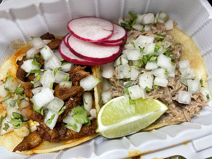 These tacos don't just satisfy hunger; they solve existential crises. Fresh cilantro and diced onion add bright notes to the richly seasoned meats.