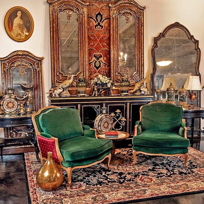 These emerald velvet armchairs flanking an ornate cabinet aren't just furniture &ndash; they're time machines to an era when "streaming" meant something entirely different.