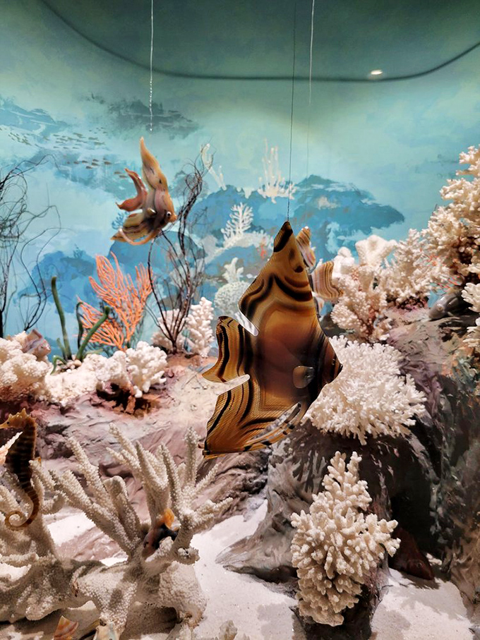 Even Nemo would be jealous of this underwater scene. Stone fish swim through carved coral in a diorama that makes you forget you're looking at rocks.