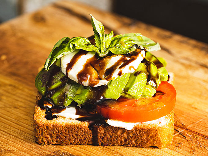 Avocado toast that makes millennials' housing decisions seem reasonable. That balsamic drizzle is performing culinary ballet across the plate.