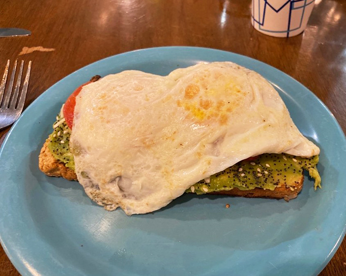 Avocado toast gets the gourmet treatment with a perfectly runny egg crowning this Instagram-worthy masterpiece.