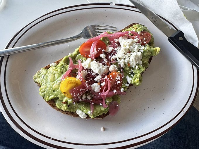 Avocado toast that makes millennials' housing decisions seem reasonable. Those pickled onions and crumbled cheese elevate this from trendy to transcendent.