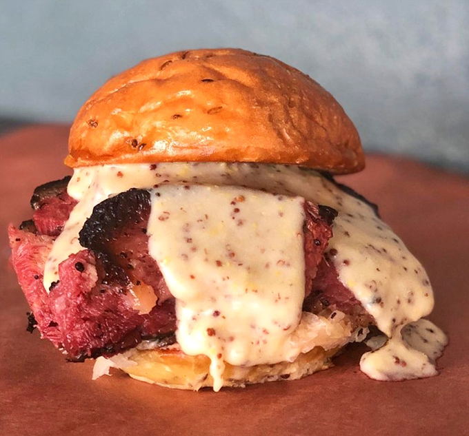 Not just a sandwich but a spiritual experience. The brisket glistens with promise while sauce cascades down like a waterfall of flavor.