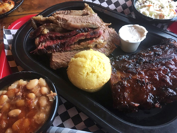 Behold the holy trinity: golden cornbread muffin, smoky meat, and beans that understand their supporting role perfectly.