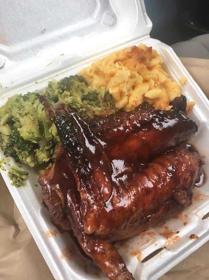 BBQ turkey wings glistening with sauce, accompanied by broccoli and mac and cheese &ndash; comfort food elevated to an art form.