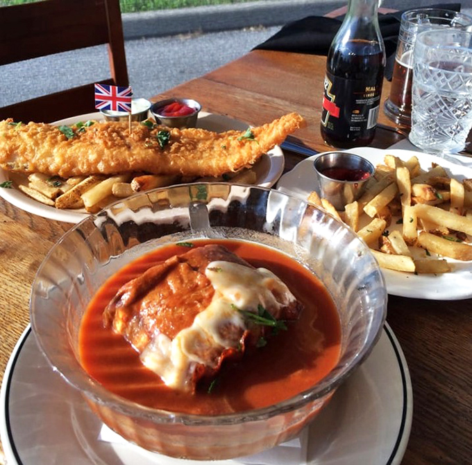 A feast for both eyes and stomach: perfectly fried fish alongside what appears to be a hearty tomato soup topped with melted cheese.