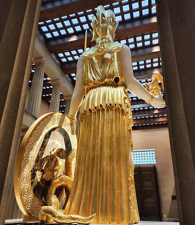 The goddess from another angle. Athena's golden form creates a stunning silhouette against the temple's interior columns.