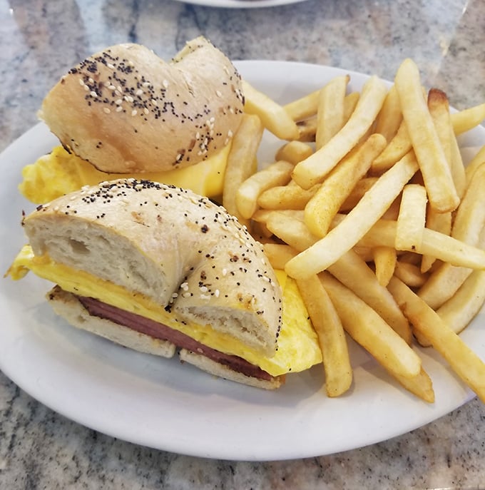 The breakfast sandwich&mdash;humanity's greatest invention after coffee. Poppy seed bagel, fluffy eggs, and ham create the holy trinity of morning satisfaction.