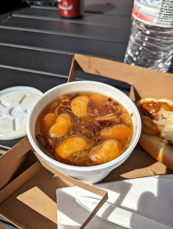 The baked butter beans aren't a side dish—they're the supporting actor who steals the scene. Swimming in a savory broth that deserves its own fan club.