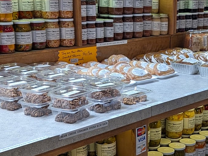 A tempting display of homemade baked goods sits beneath jars of preserves, creating a sweet-and-savory dilemma that's the best kind of problem to have.