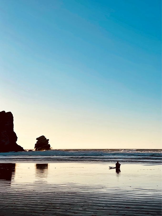 Golden hour transforms the beach into a painter's dream. A solitary photographer captures what words can't quite describe&mdash;California coastal magic in its purest form.
