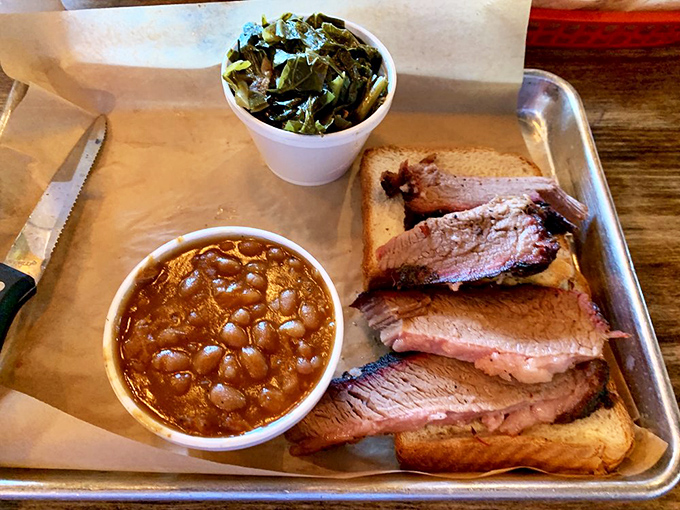 The holy trinity of barbecue bliss: tender brisket, soul-satisfying beans, and collards so good they might make you consider moving to Georgia.