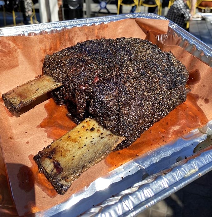 The prehistoric-looking beef rib, encrusted with pepper and smoke, is what Fred Flintstone would order for his anniversary dinner.