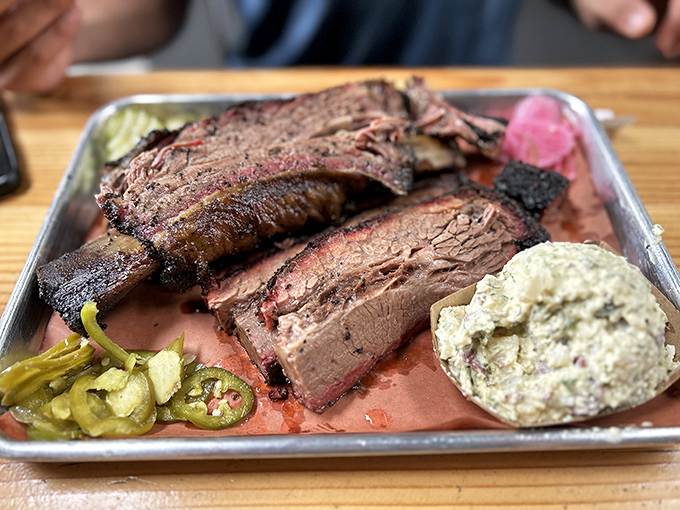 These beef ribs aren't just dinner&mdash;they're prehistoric monuments to smoking perfection, flanked by pickled jalape&ntilde;os that cut through the richness like witty banter.
