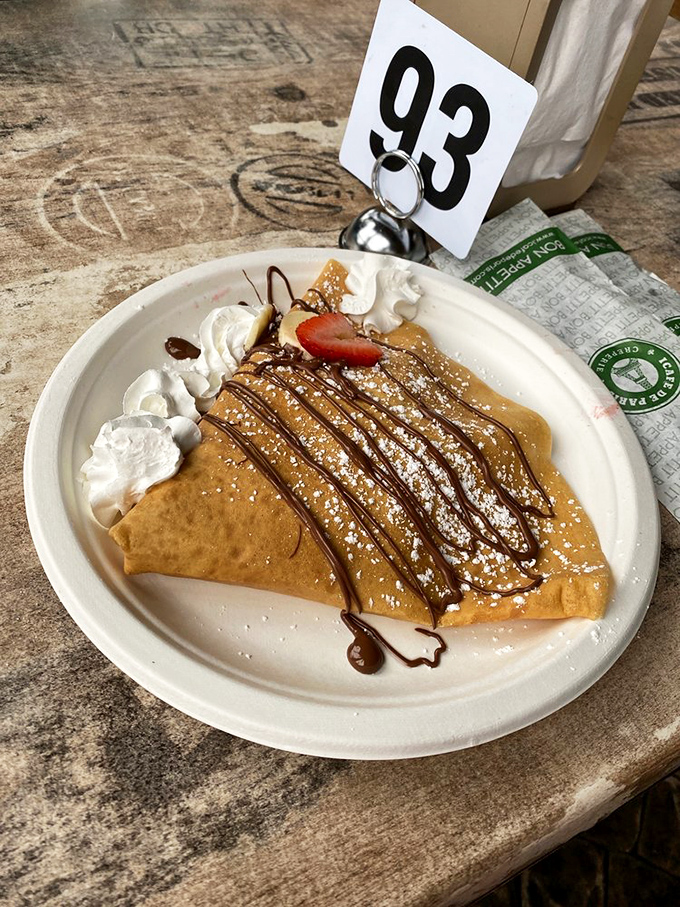 A sweet crepe drizzled with chocolate and topped with whipped cream—proof that sometimes the best souvenirs come on a plate.