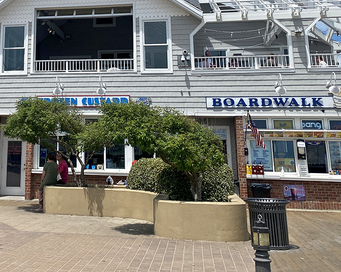 The boardwalk shops beckon with promises of coastal treasures. Here, "window shopping" means literally pressing your nose against the glass for a glimpse of beach-town charm.