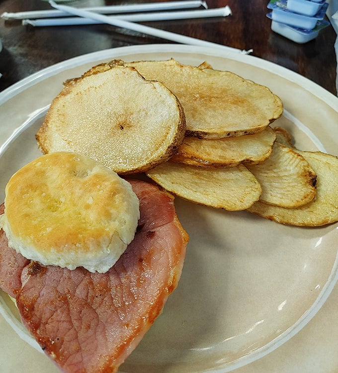 Country ham and a biscuit that could make a grown person weep, served with homemade potato chips that snap with each bite.