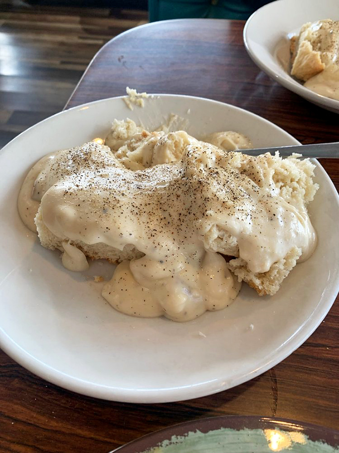 Biscuits and gravy so comforting it's like a warm hug from your favorite grandma, with pepper specks adding just enough personality to keep things interesting.