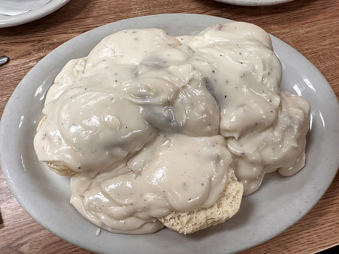 Behold the holy grail of breakfast: biscuits so fluffy they practically float beneath perfect gravy.