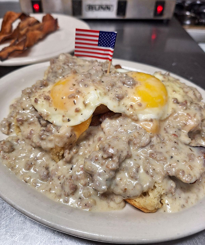 Biscuits and gravy so authentic they deserve their own country song, topped with an egg whose yolk is about to steal the show.