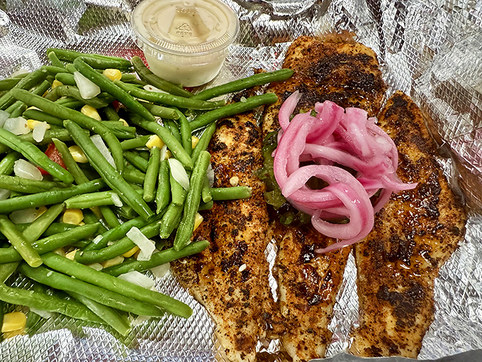 Blackened mahi that doesn't need a filter – just pink onions, green beans, and spices that could make a vegetarian question their life choices.