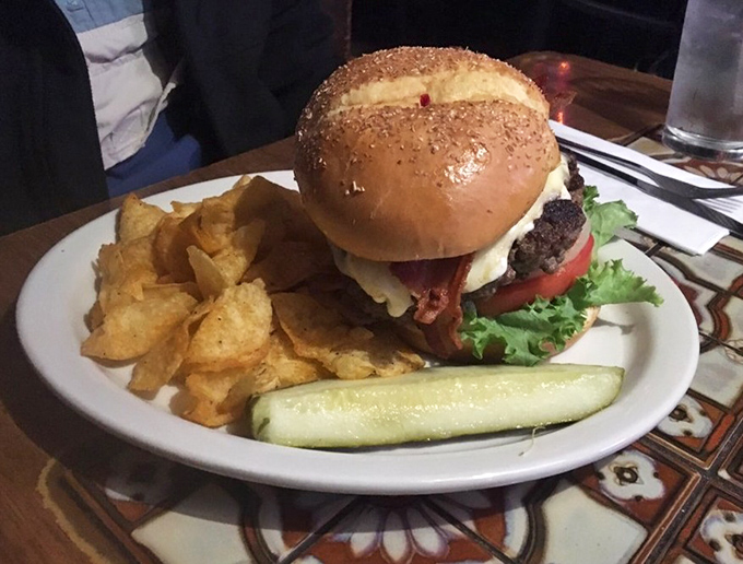 This isn't just a burger&mdash;it's a commitment. The pickle spear stands like a flag planted on a delicious mountain of beef, bacon, and melted cheese.