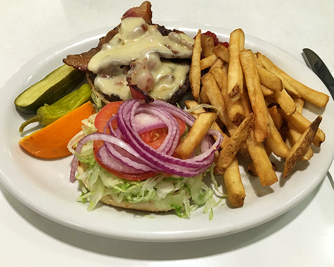 This isn't just a burger&mdash;it's architecture with cheese, where every layer from the melty top to the garden-fresh fixings plays its perfect role.