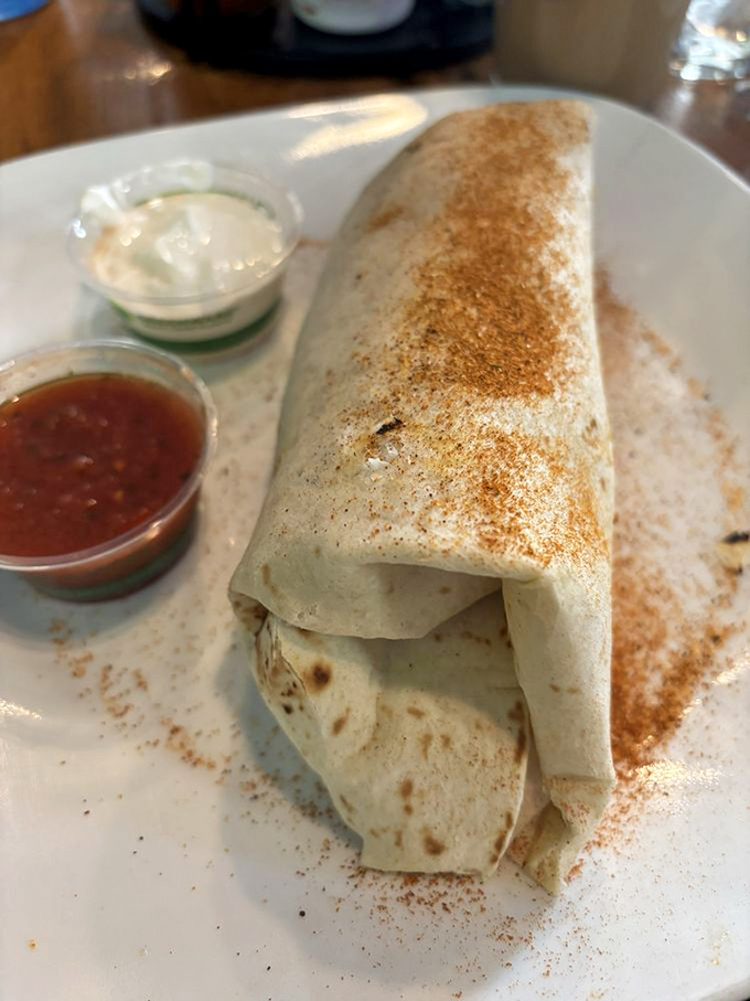 This breakfast burrito isn't just wrapped, it's embraced&mdash;a warm hug of tortilla cradling morning goodness with a sprinkle of cinnamon charm. 