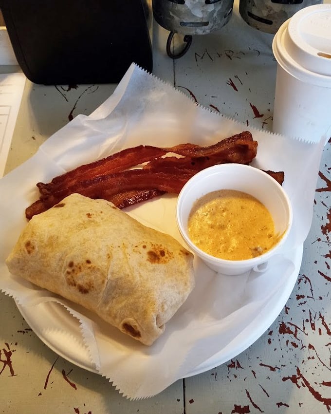 Breakfast's greatest hits wrapped in a tortilla. That bacon looks like it auditioned for a food commercial and got the starring role.