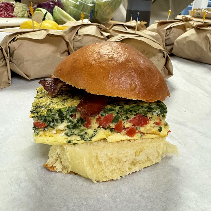 Breakfast sandwich nirvana achieved! Fluffy eggs studded with vegetables nestled between slices of freshly baked bread &ndash; the morning commute's greatest reward.