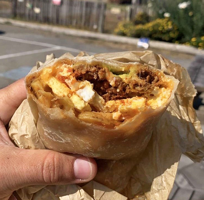 Breakfast goes portable with this hearty burrito. The perfect hand-held companion for coastal explorations, wrapped in paper like a delicious gift to yourself.