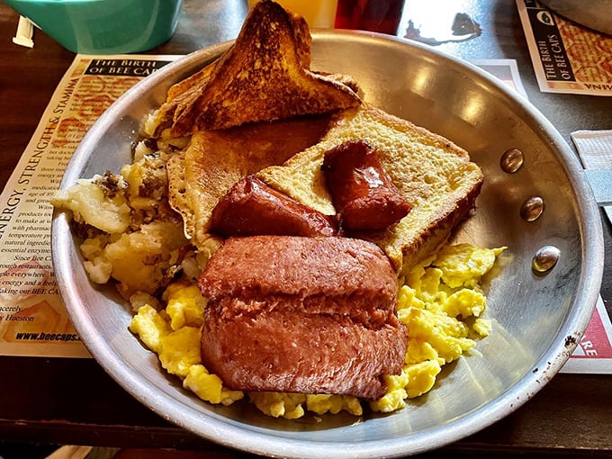 Breakfast alchemy at its finest &ndash; eggs, toast, and meat arranged on a metal plate like a morning symphony. No filter needed.