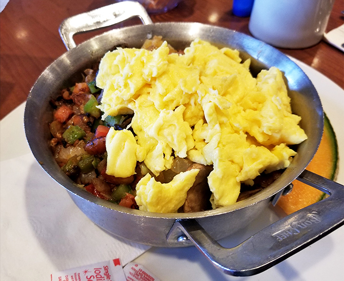 Breakfast skillet magic&mdash;where farm-fresh eggs crown a kingdom of perfectly seasoned vegetables and potatoes in cast iron splendor.