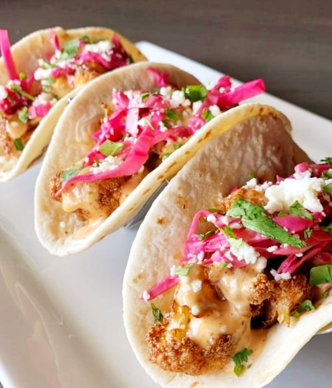 These fish tacos bring the beach to Ohio with crispy battered fish, vibrant pickled onions, and fresh herbs creating a fiesta of flavors.