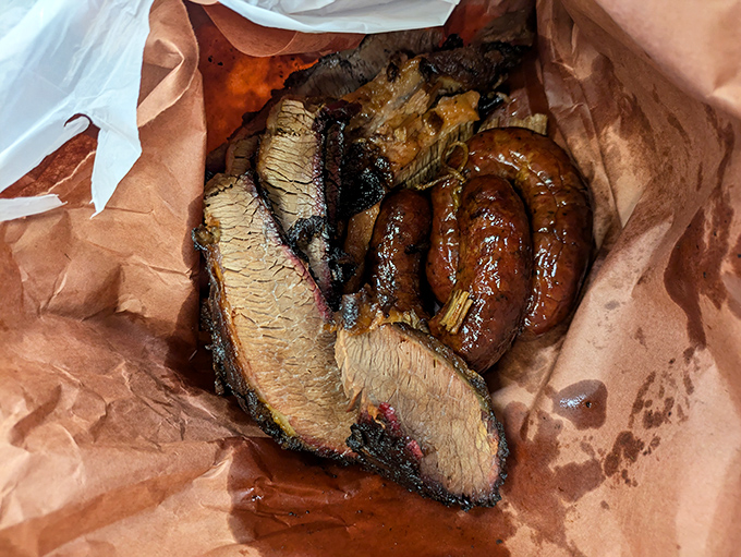 This brisket and sausage combo isn't just lunch; it's a Texas heritage moment wrapped in butcher paper instead of a history book.