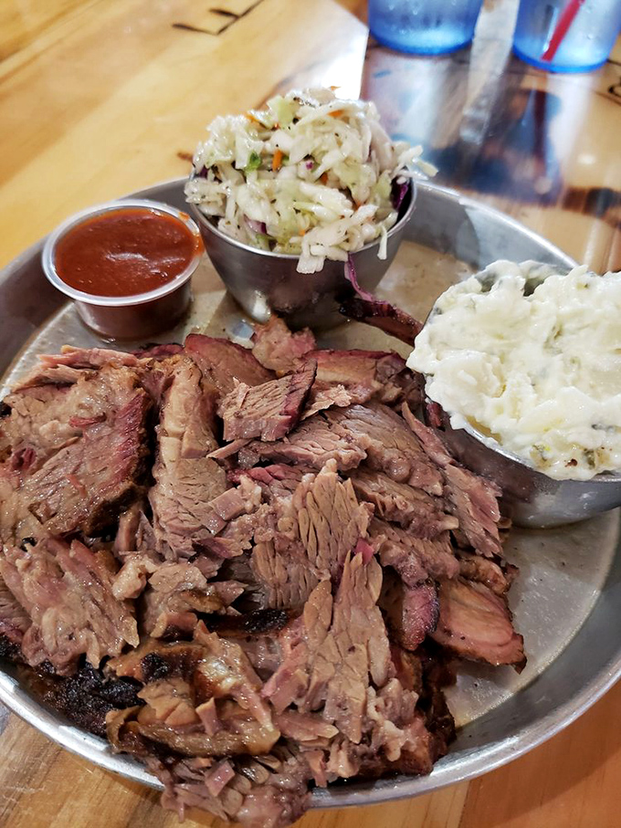 Brisket so tender it practically surrenders to your fork. This smoky mountain of meat, accompanied by creamy slaw and potato salad, is Arizona's answer to Texas tradition.
