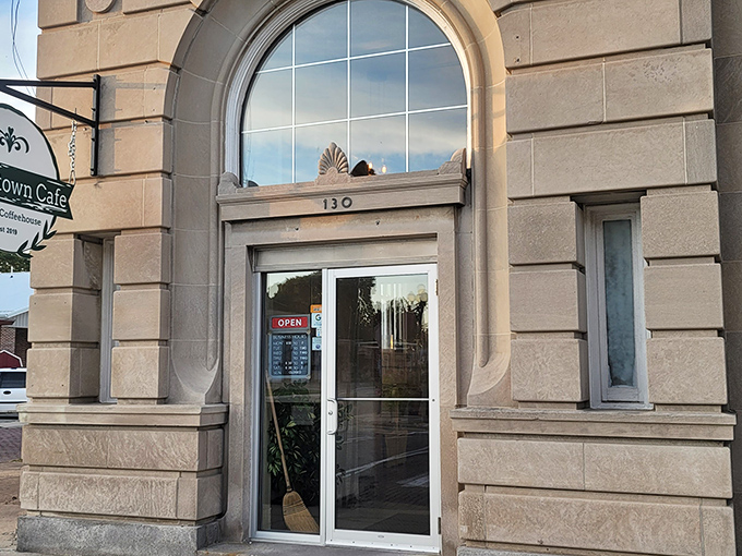 The elegant arched entrance of this historic building now welcomes hungry visitors to the Broomtown Cafe, where local flavors meet in a space that whispers stories of the past.