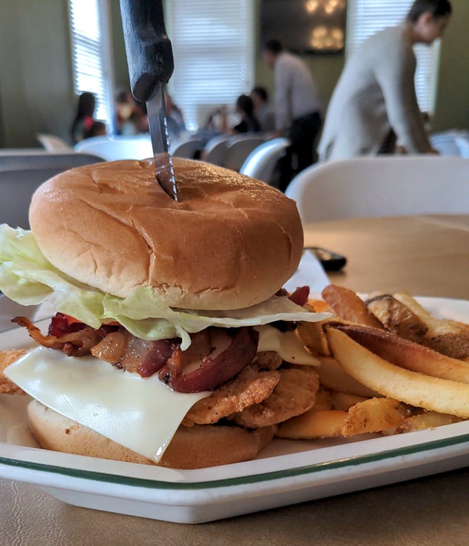 A burger that requires both hands and possibly a nap afterward. Those fries aren't just sides&mdash;they're co-stars in this lunch production. 