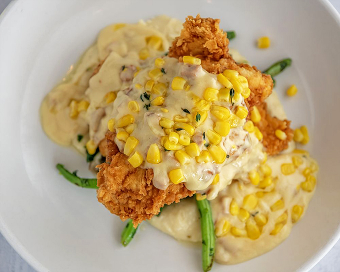 Southern comfort meets culinary artistry&mdash;this buttermilk fried chicken with corn cream sauce might make you temporarily forget you're in a seafood restaurant.