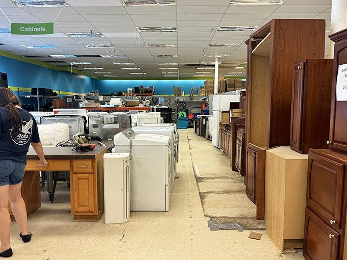 The appliance aisle: where washing machines and cabinets enjoy their intermission before joining the cast of someone's kitchen renovation.