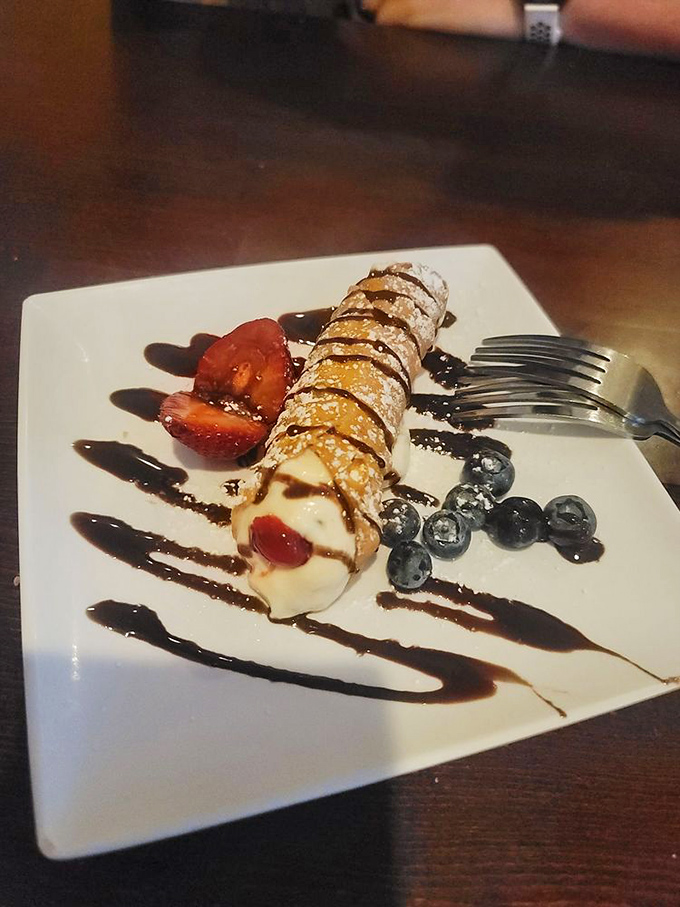 This cannoli isn't just dessert, it's edible architecture - a crispy exterior giving way to sweet, creamy filling that would make any Sicilian grandmother nod in approval.